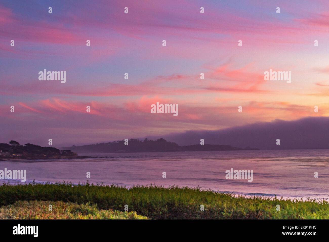 A sunrise over the frozen lake, cloudy and purple sky in the background ...