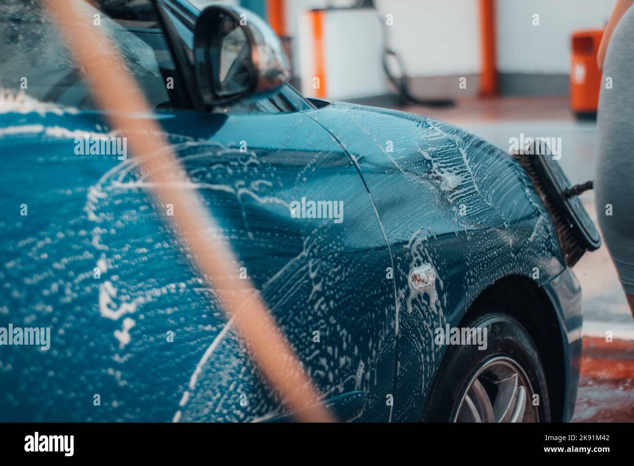 The blue car in the auto wash Stock Photo - Alamy