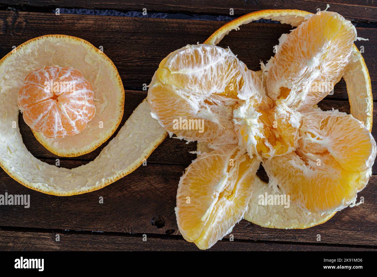 mandarin orange peeled in half on the peel in squares Stock Photo - Alamy