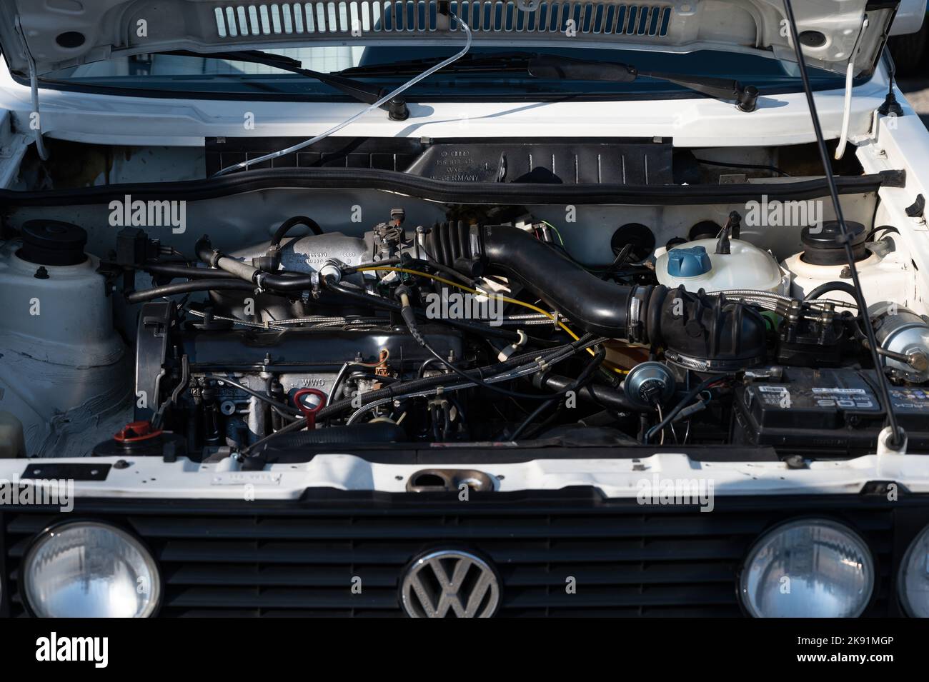The detail of the engine of an old white Volkswagen Golf second ...