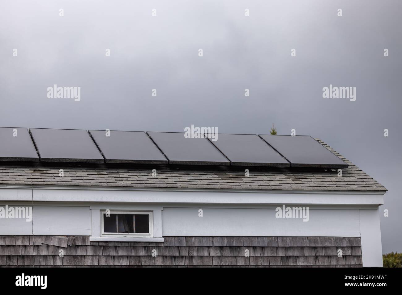 The solar panels on the roof of an old New England home on Martha's ...