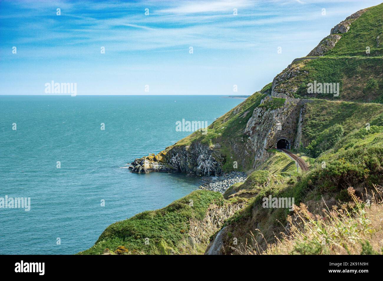 The beautiful rocky green cliffs over the water near Bray and ...