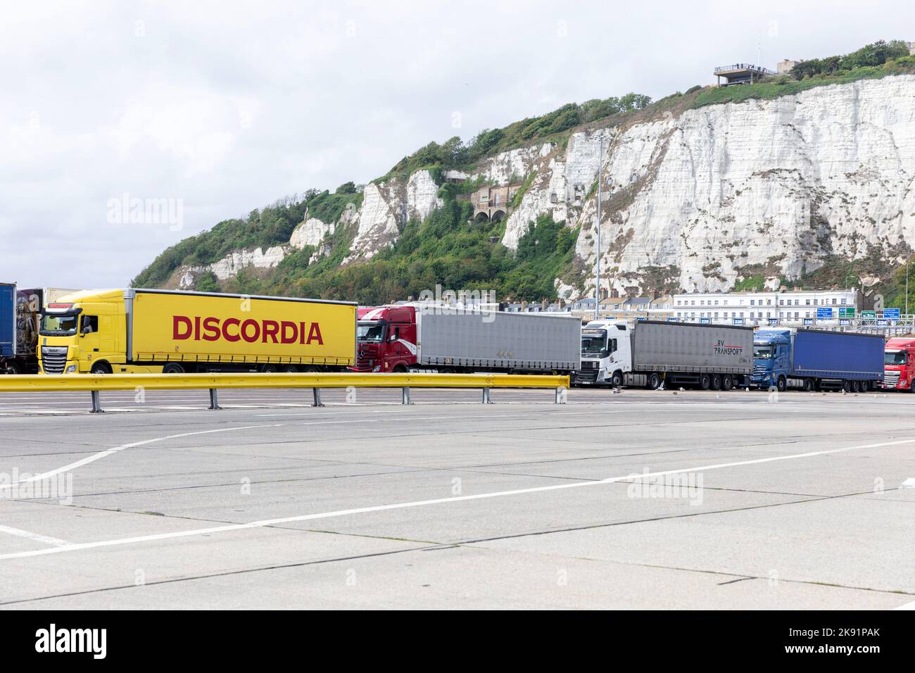 Freight lorries, parked at Port of Dover. A yellow Discordia Lorry in ...
