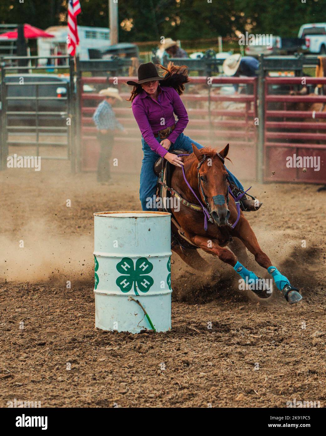 A vertical shot of a cowgirl barrel racing at the Wyandotte County ...