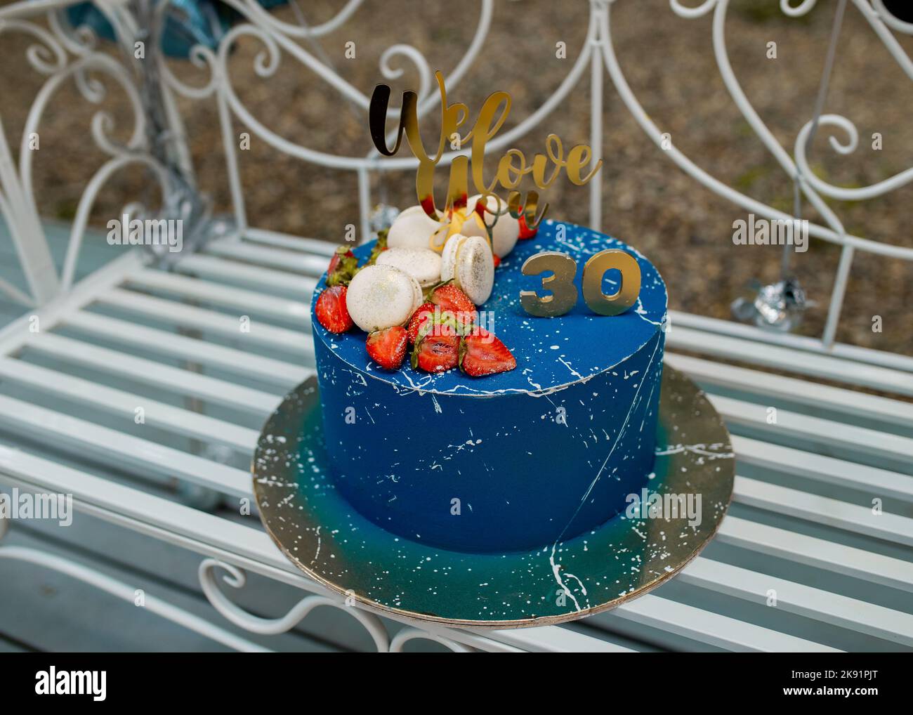 30 years anniversary blue cake with strawberries on golden plate Stock ...