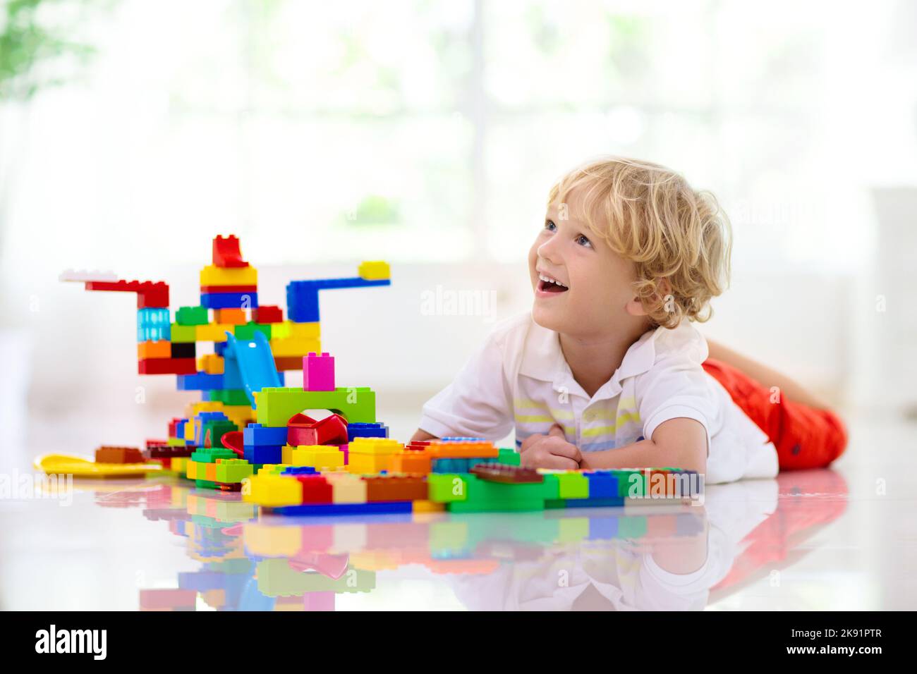 Child playing with colorful toy blocks. Kids play with plastic bricks ...