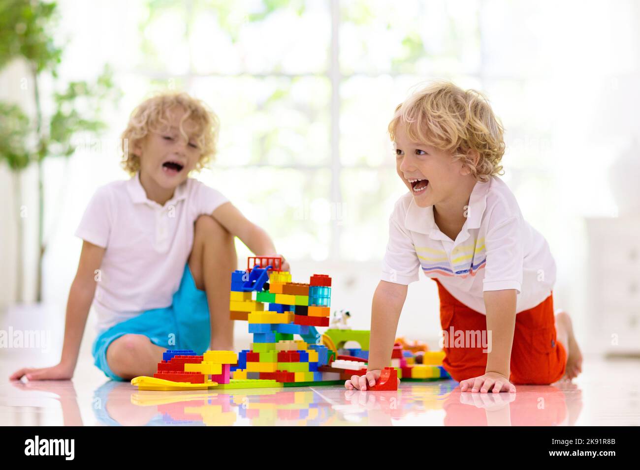 Child playing with colorful toy blocks. Kids play with plastic bricks ...