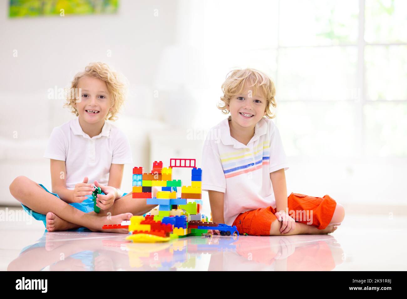 Child playing with colorful toy blocks. Kids play with plastic bricks ...