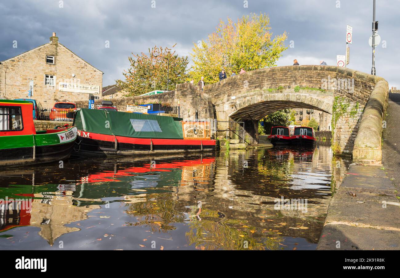 Tourists walking over a bridge in Skipton spanning the Spring branch of ...