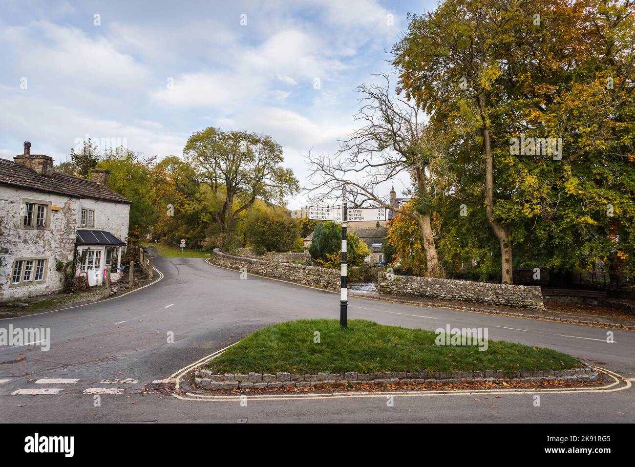 An old sign post on a grass triangle in the village of Malham ...