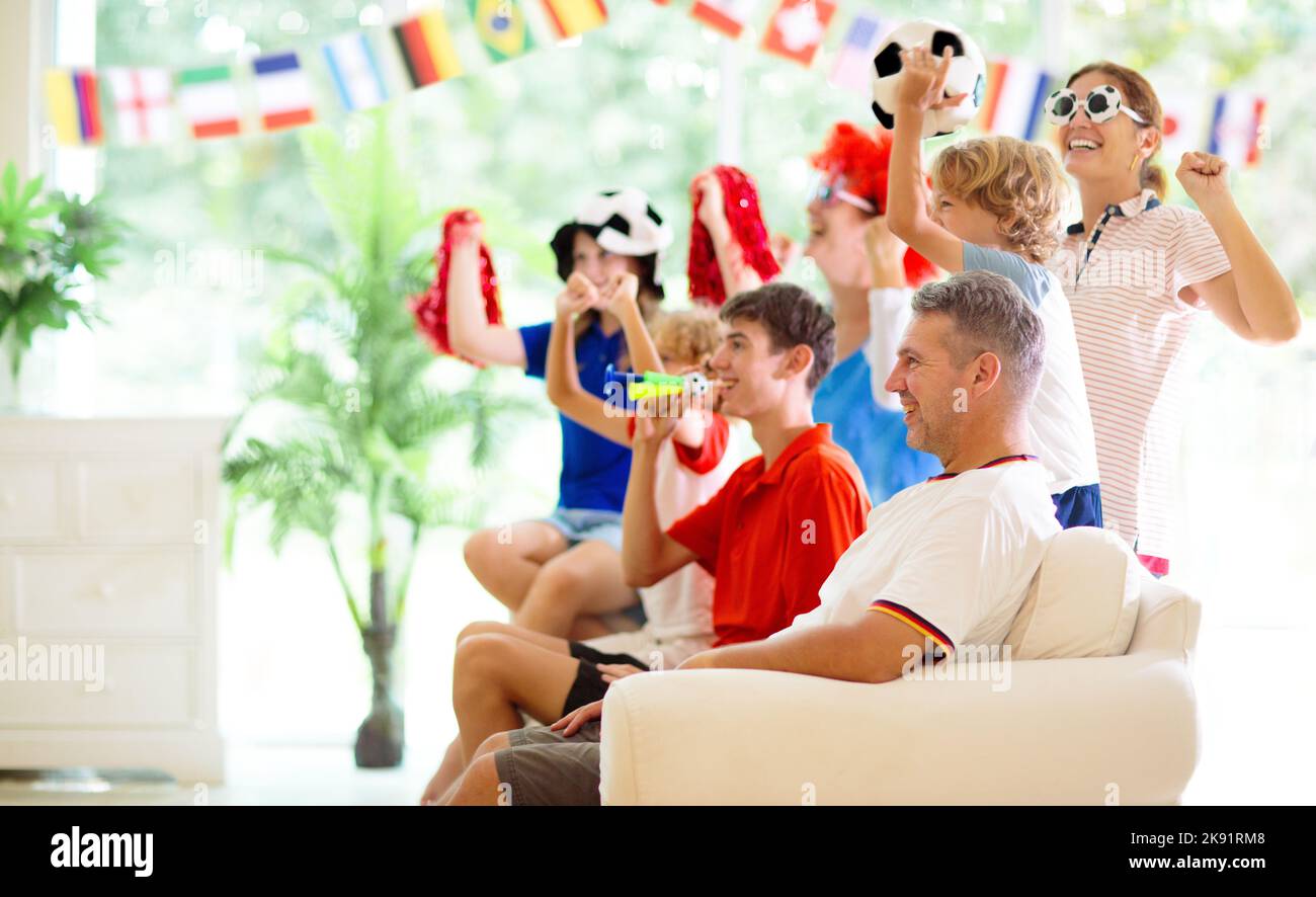 Group of football fans watch tv at home. Friends watching soccer match ...