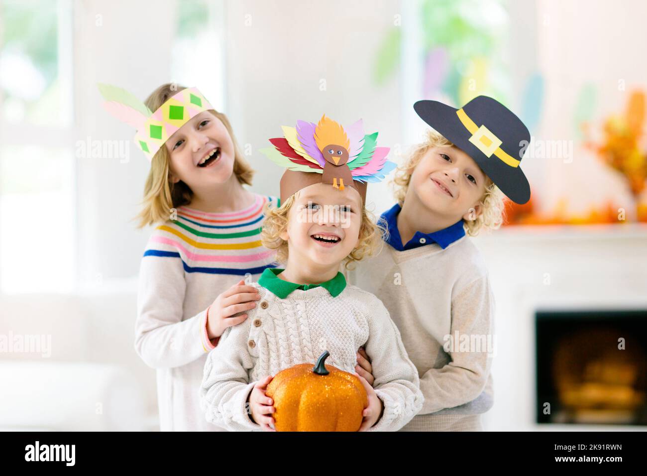 Child celebrating Thanksgiving. Kid in paper turkey hat, native ...