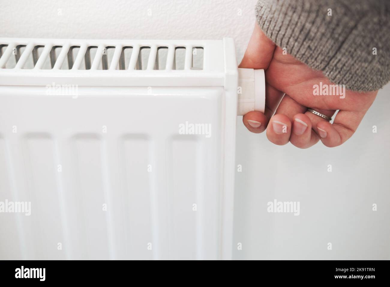 Turning down thermostat of a central heating radiator. Energy saving ...