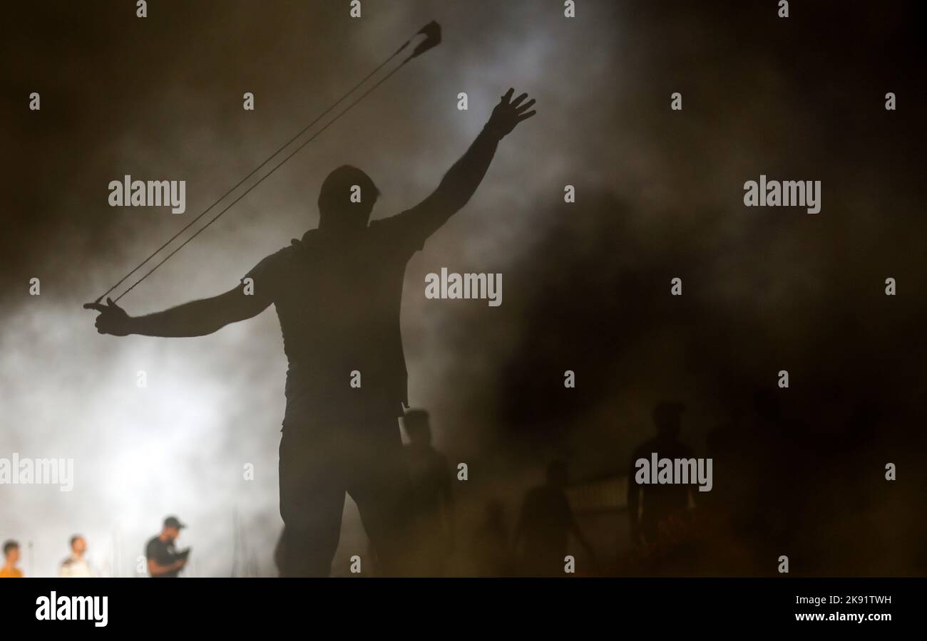 Gaza City, 25/10/2022, A Palestinian protester uses a slingshot to hurl ...