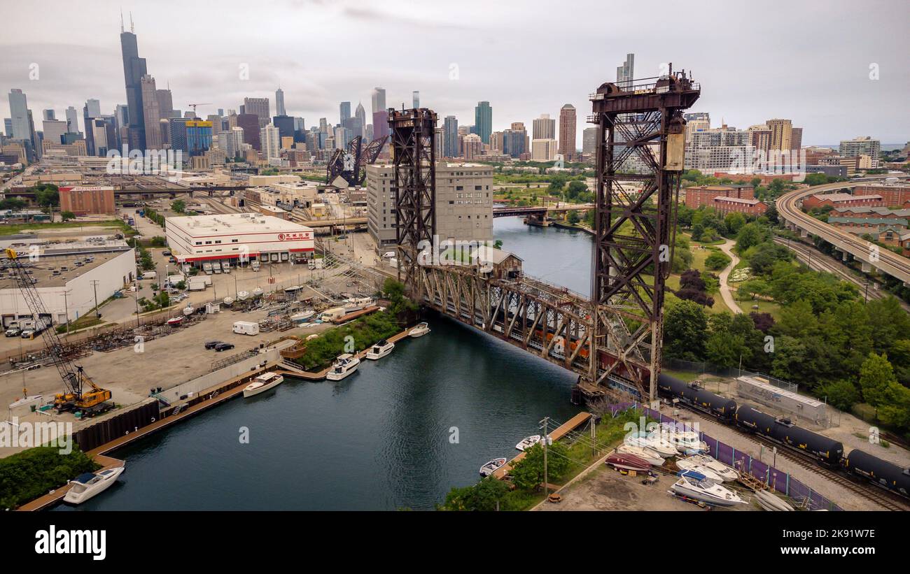 An aerial drone view of a boat sailing on the Chicago river under a ...