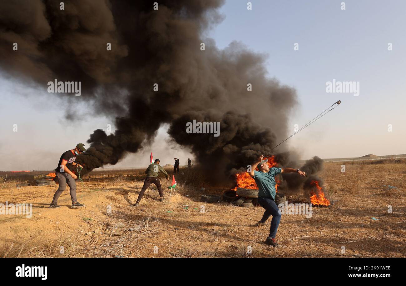 A Palestinian protester uses a slingshot to hurl stones during the ...