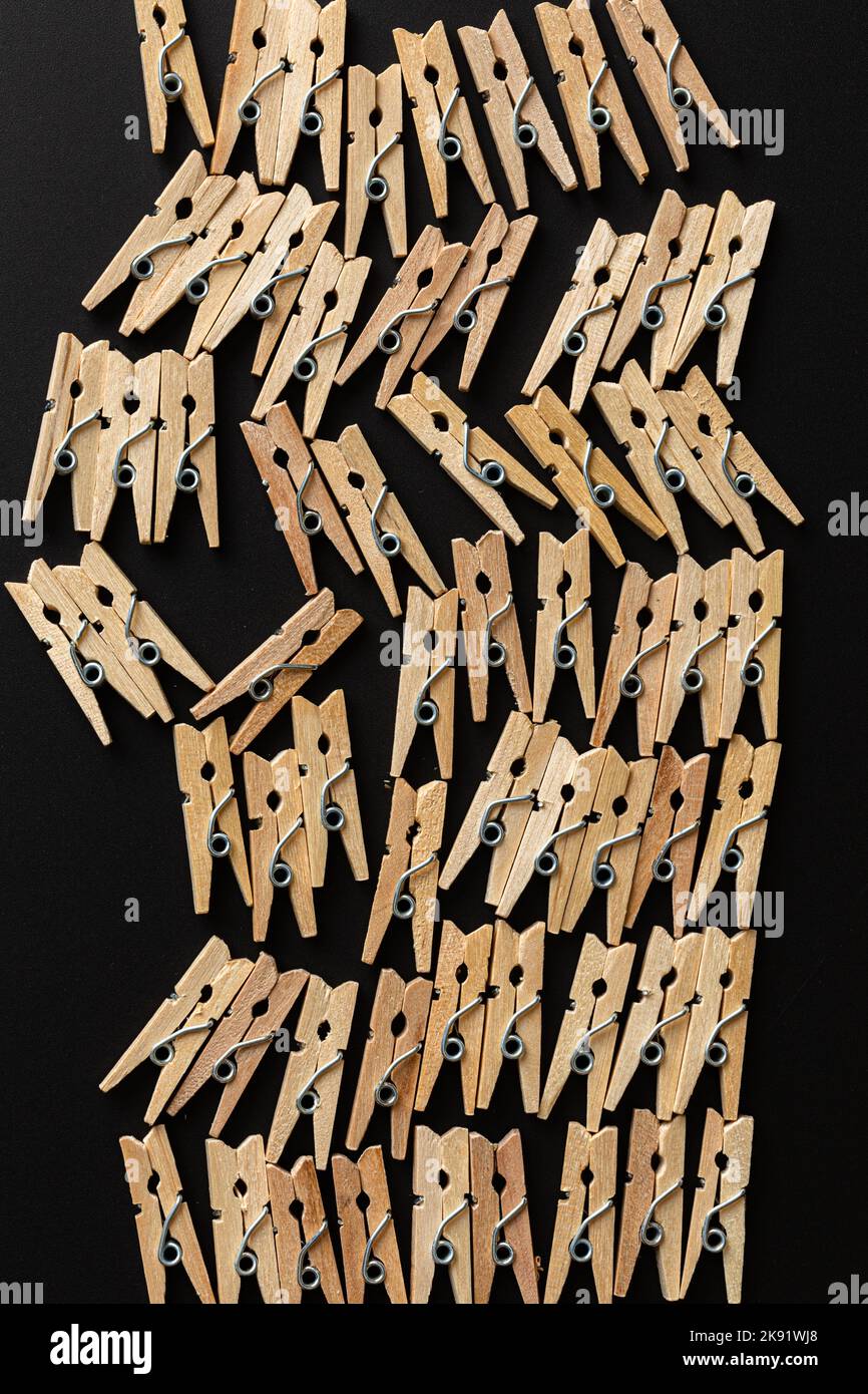 Row wood clothespins on black background Stock Photo - Alamy
