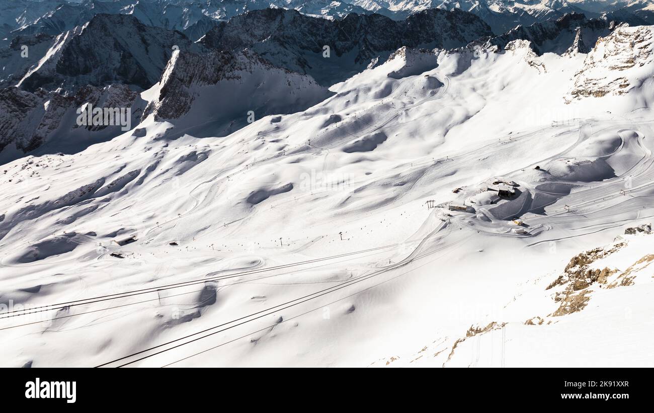 An aerial view of white snow-covered mountains in Austria-Germany ...