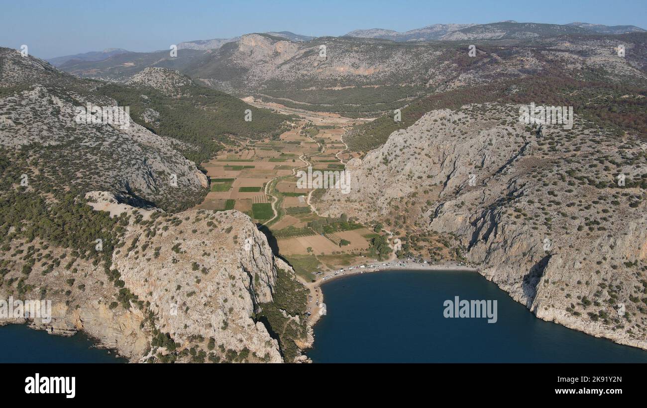 An aerial view of a beautiful cove with clear water and cliffs on a ...