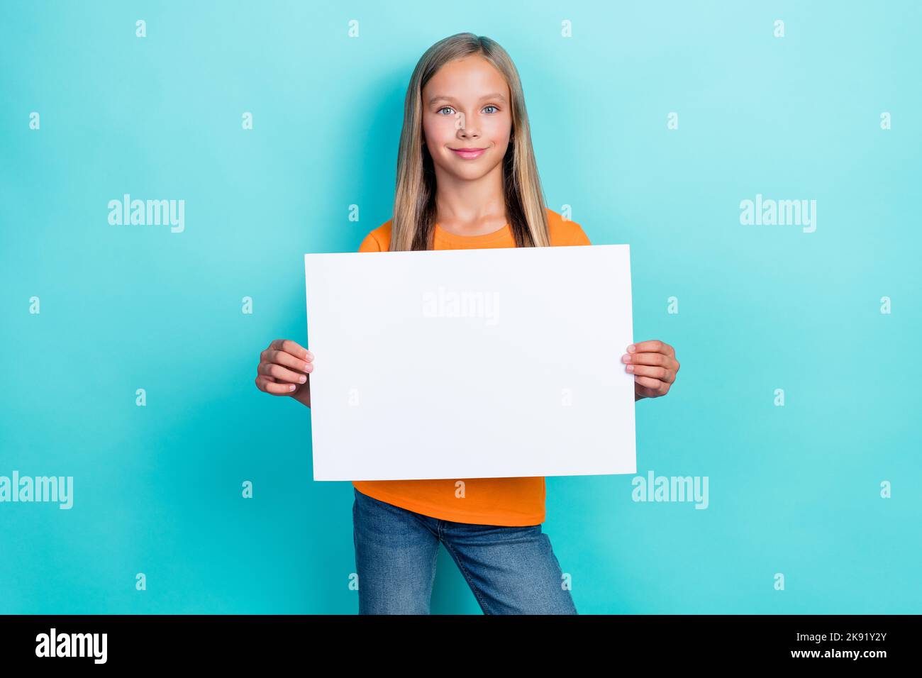 Photo of positive schoolkid girl hold white paper placard positive ...