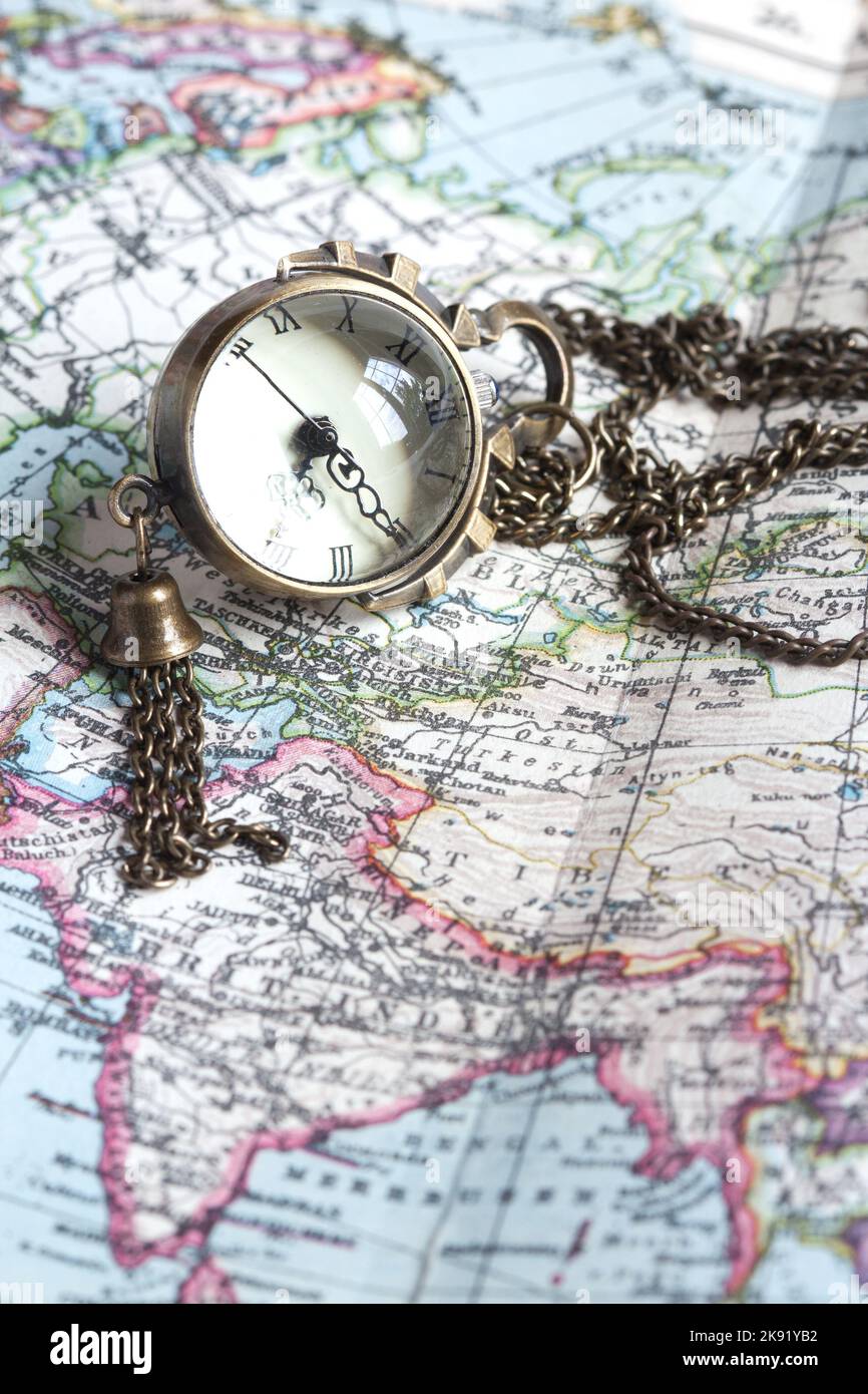 Old watch with sphere surface on antique map Stock Photo - Alamy