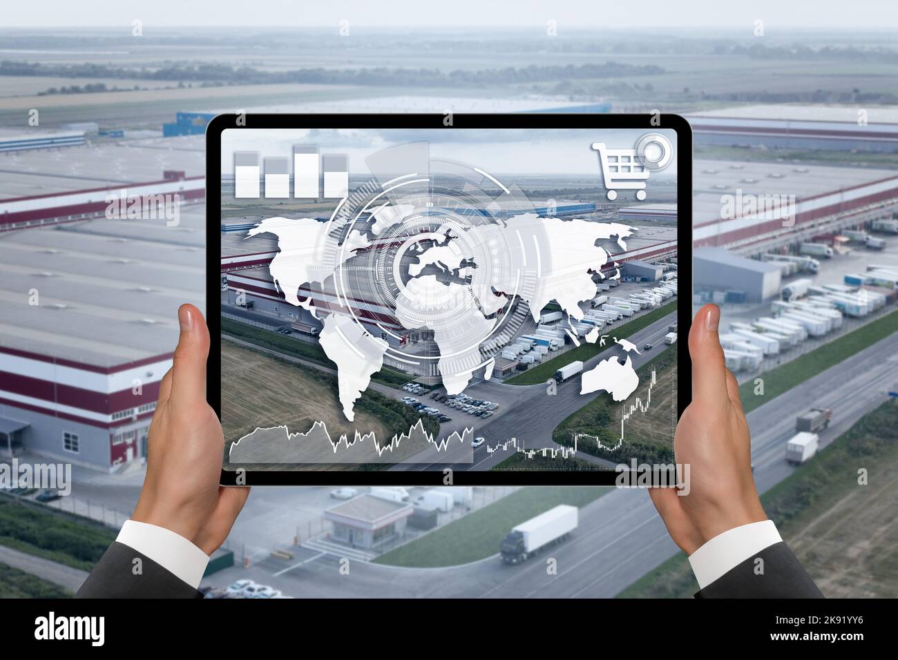 Hands with digital tablet on the background of a logistic centre ...