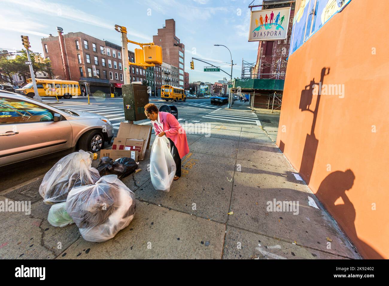 NEW YORK, USA - OCT 21, 2015: woman poses garbage at the street in ...