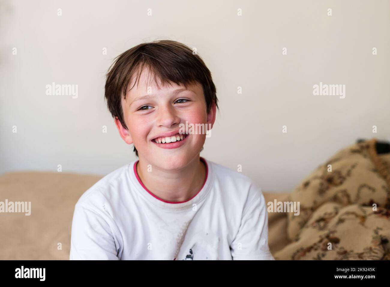 teen boy at home with a happy and cool smile on face. Lucky person ...