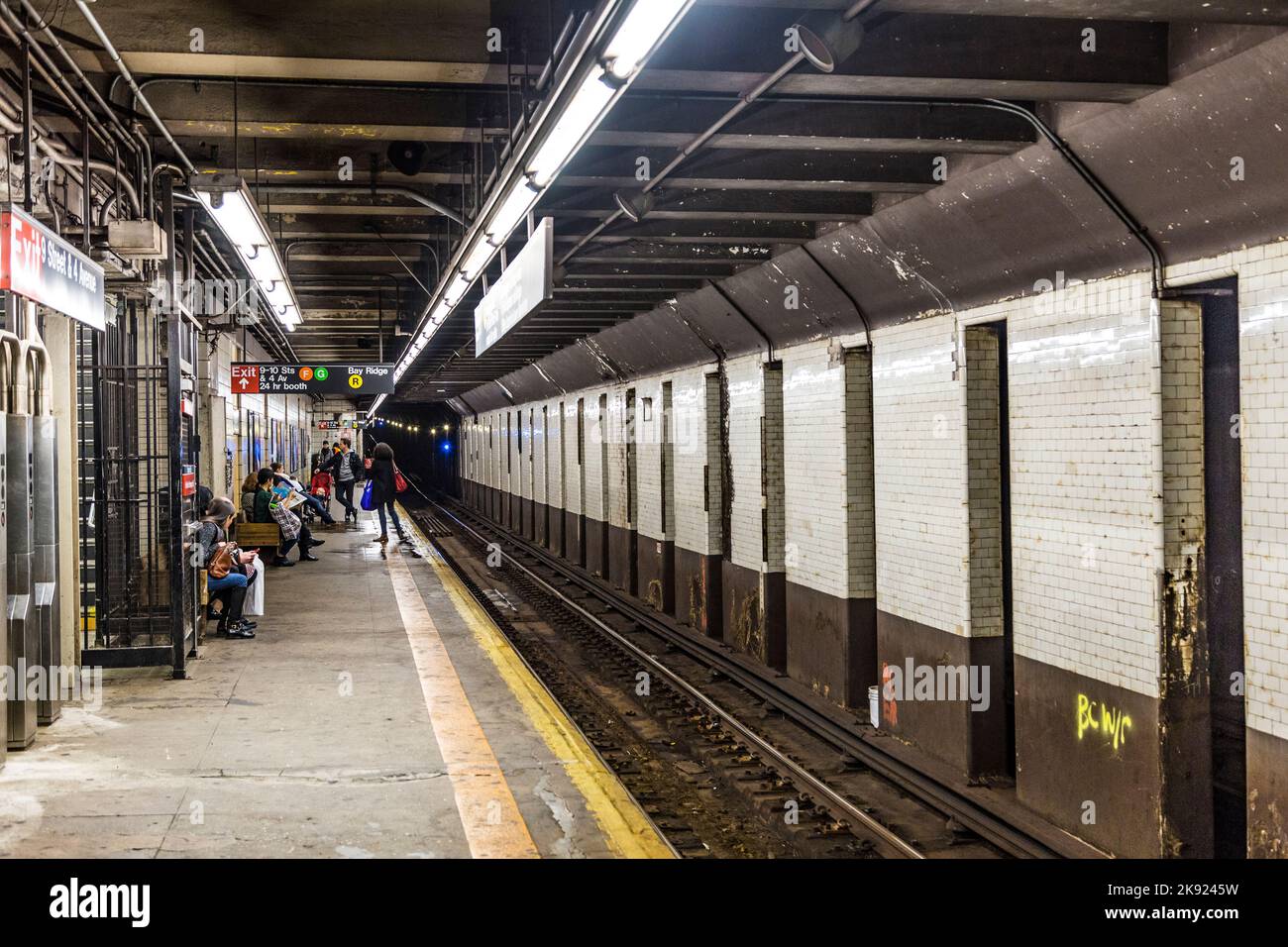 NEW YORK, USA - OCT 25, 2015: People wait at subway station 9th street ...