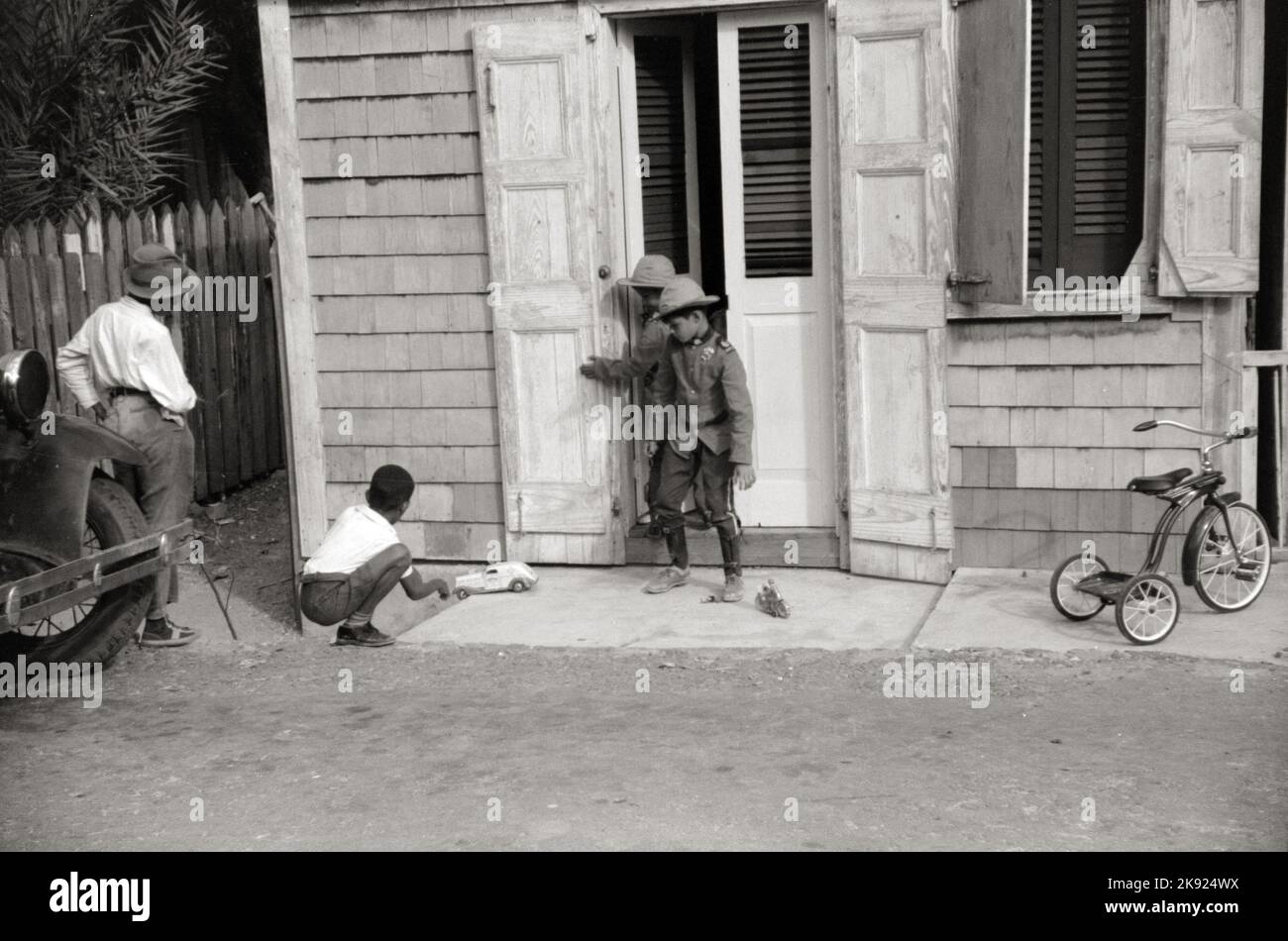 Children playing with their Christmas toys on a side street Dec 1941 ...
