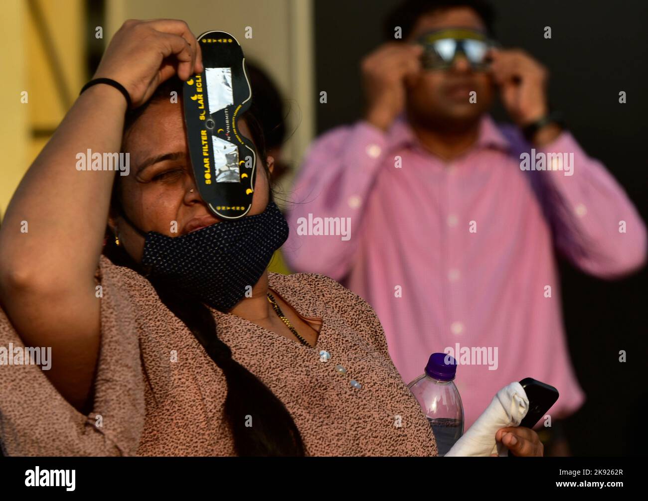 MUMBAI, INDIA - OCTOBER 25: People watch partial solar eclipes through ...