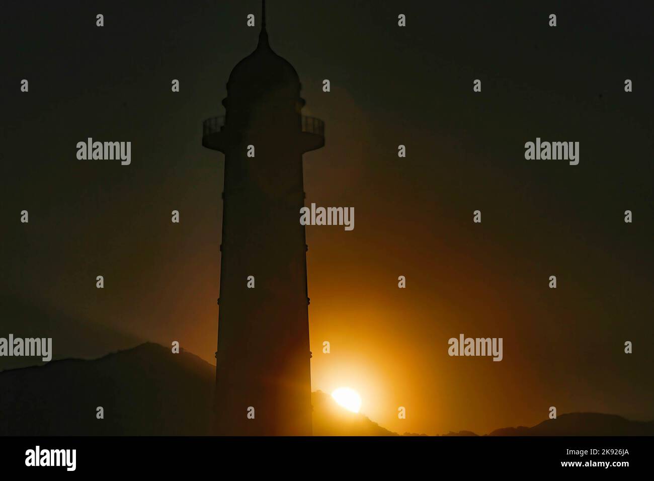 A partial solar eclipse is seen behind the Dharahara tower in Kathmandu ...