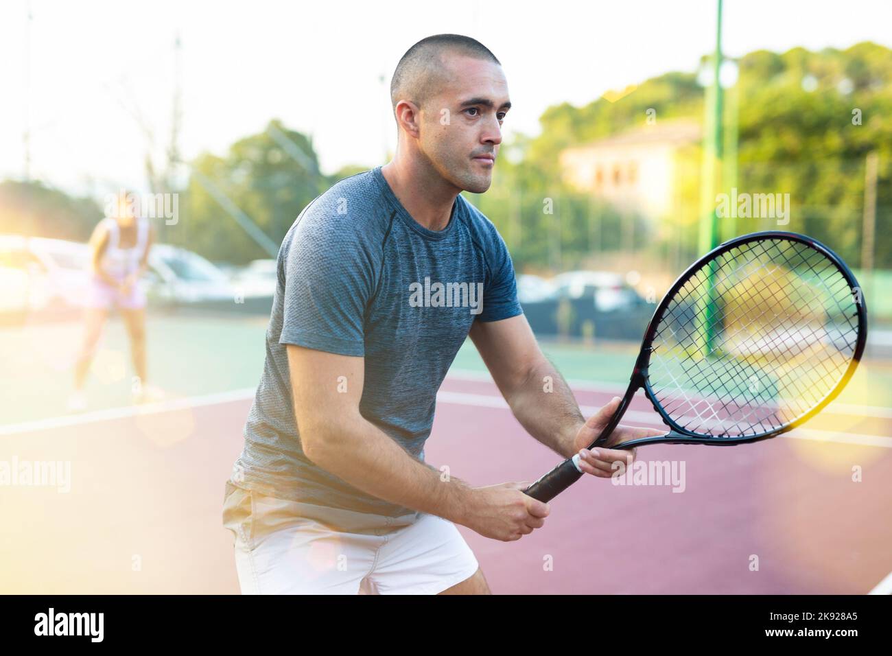 Man playing tennis on court Stock Photo - Alamy