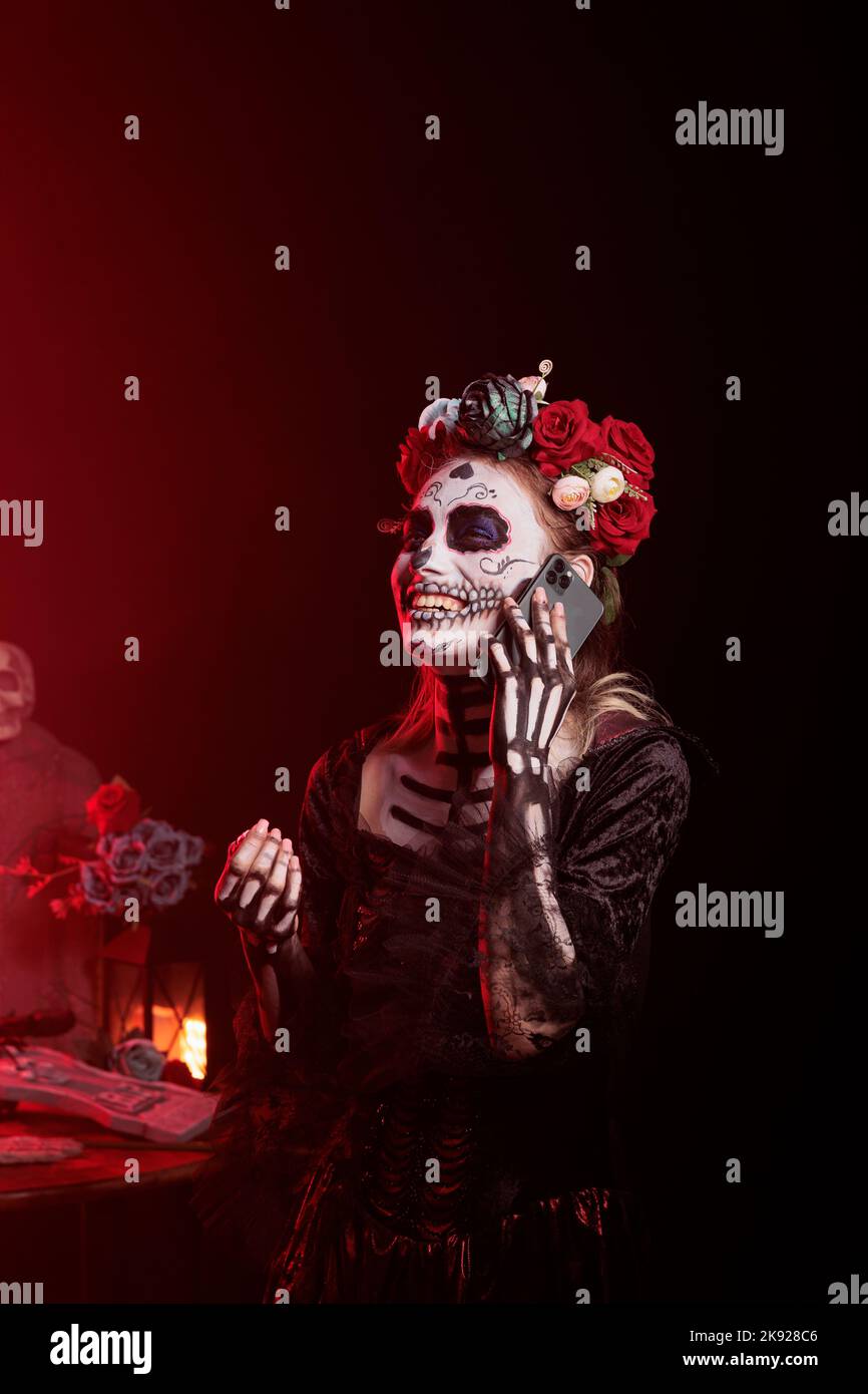 Spooky goddess talking on phone call with smartphone, wearing flower ...