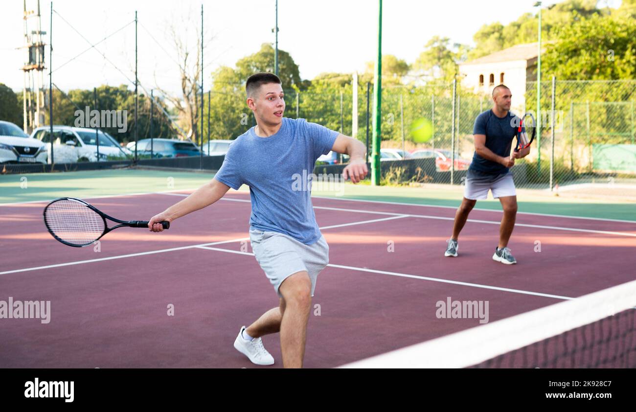 Sports active man during friendly doubles couple match. Two men playing ...