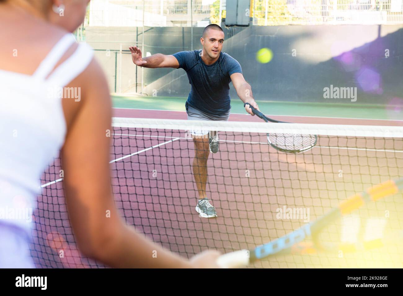 Focused young man playing friendly tennis match. Concept of ...