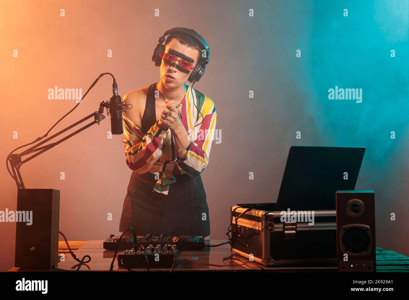 Female DJ artist doing prayer hands symbol and begging for hope and ...