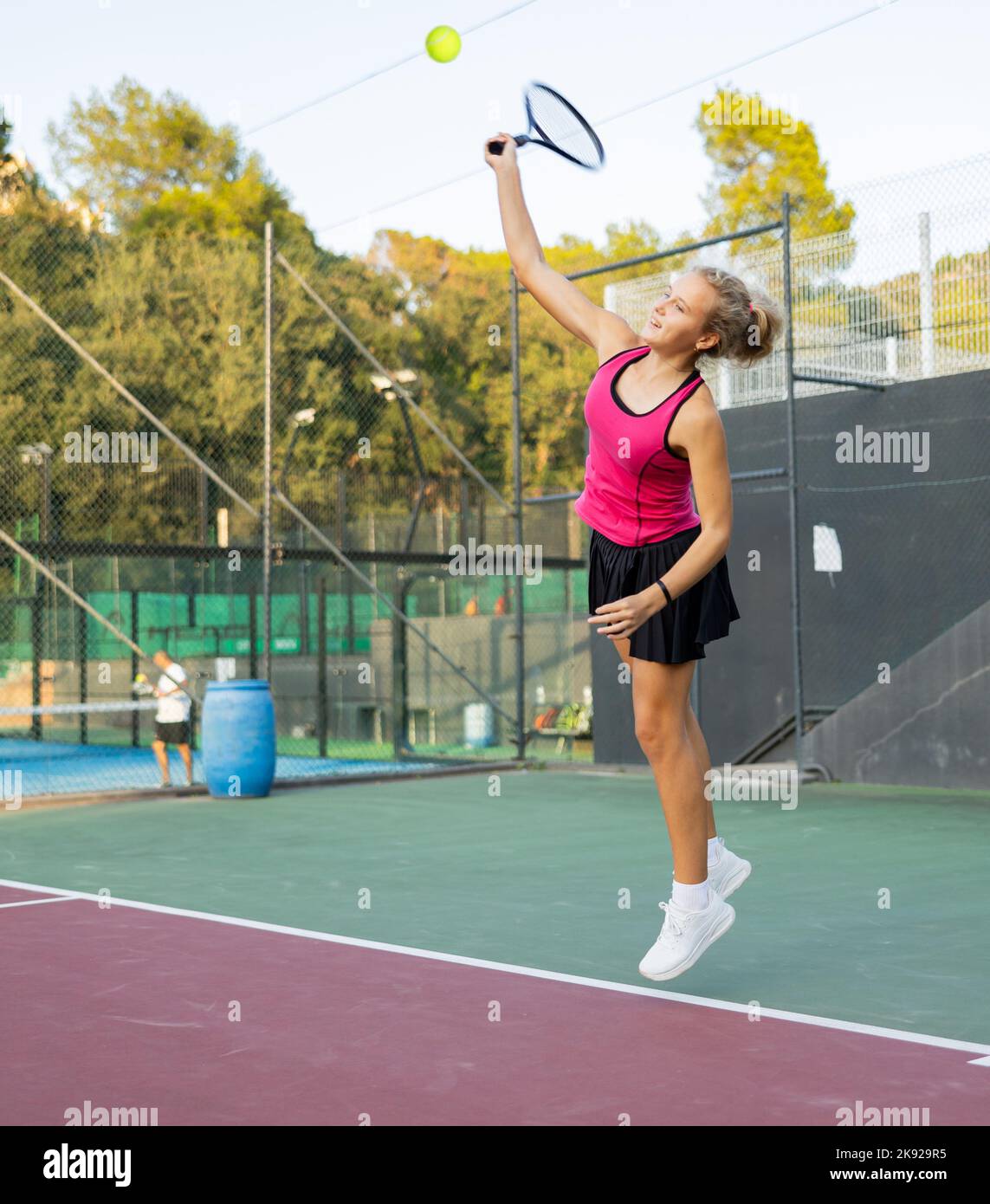 Girl playing tennis ball friendly match on outdoors court Stock Photo ...