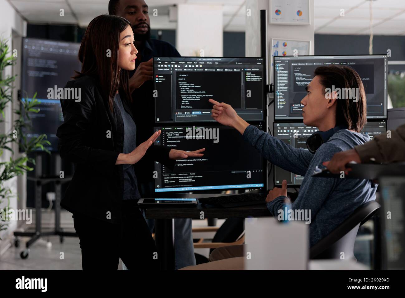 Diverse Team Of Programmers Coding Html Script Information On Computer At Desk Table Parsing