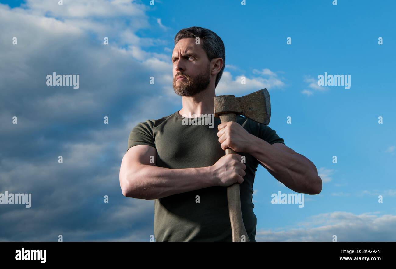strong man with axe. lumberman man hold ax. brutal man on sky ...