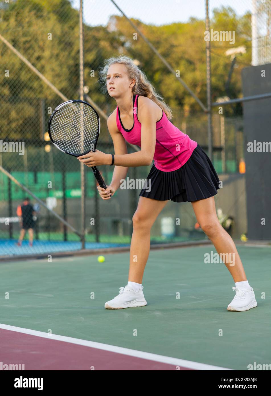 Woman tennis player training on court Stock Photo - Alamy