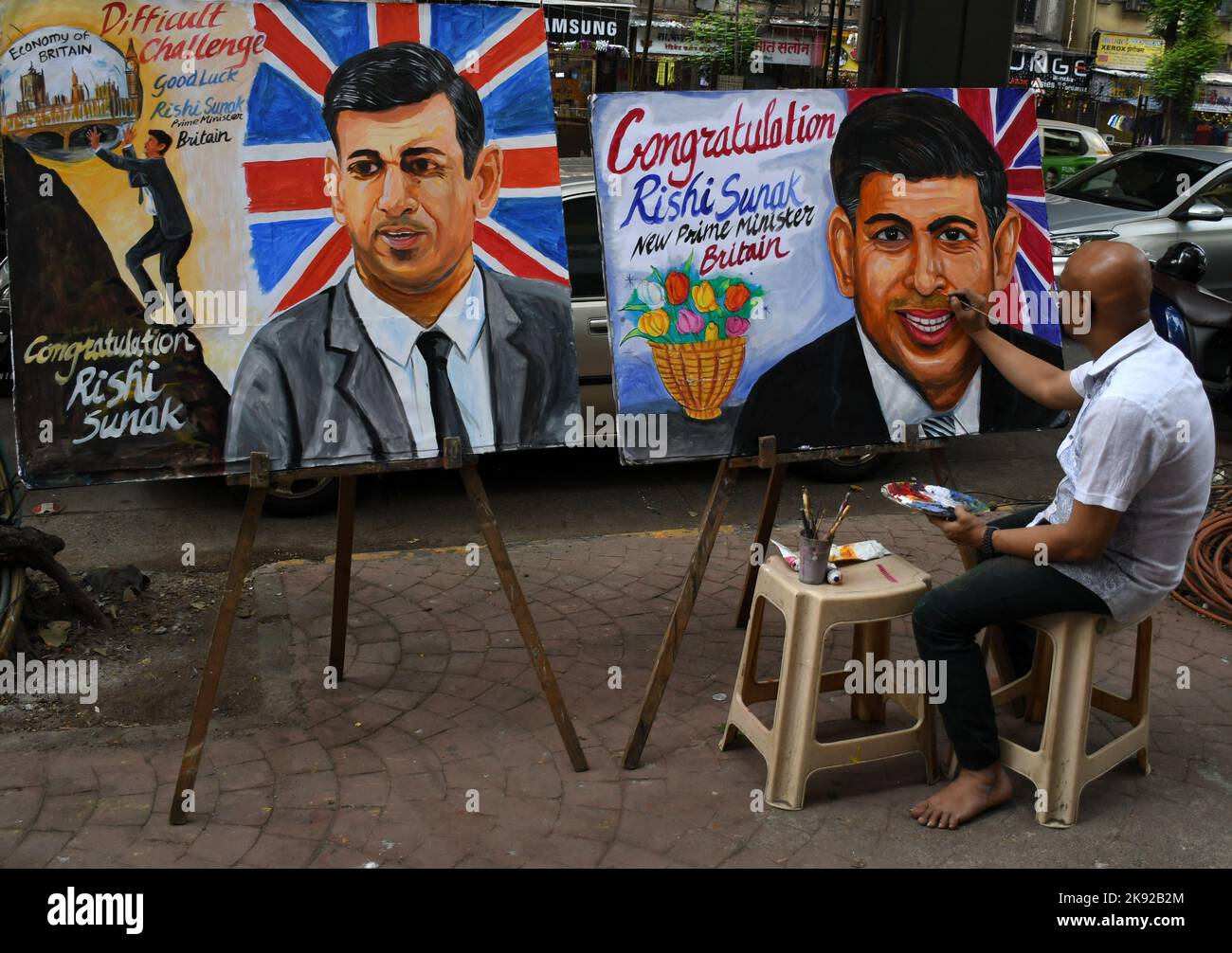 An artist puts finishing touches to the painting of Rishi Sunak at ...
