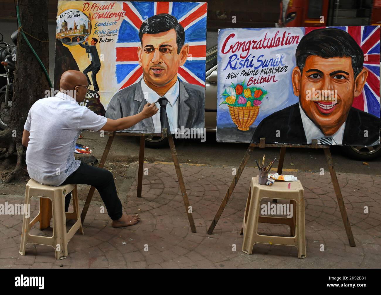 An artist puts finishing touches to the painting of Rishi Sunak at ...