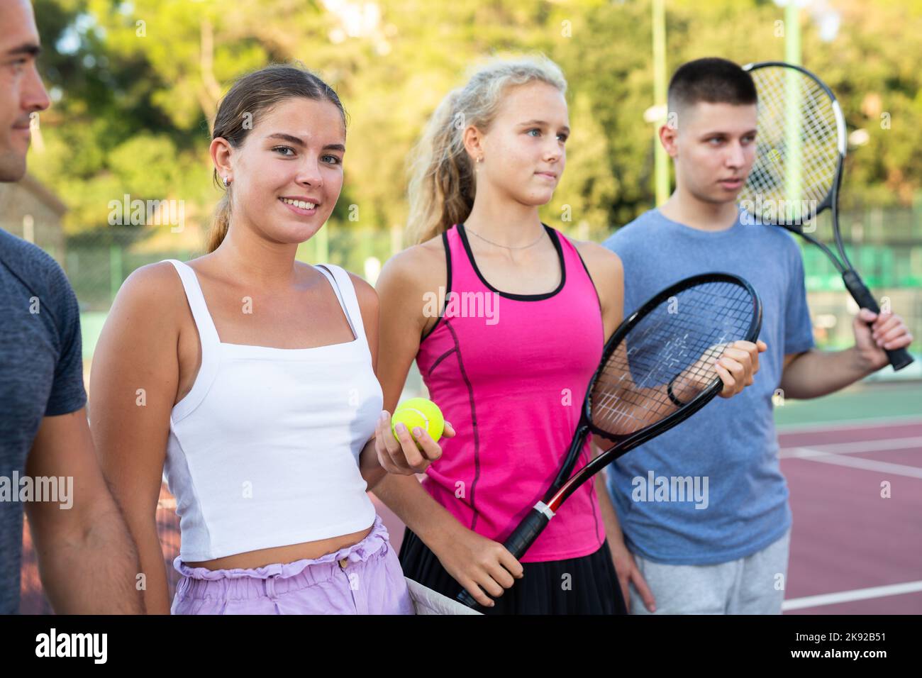 Group photo of positive people on tennis court Stock Photo - Alamy