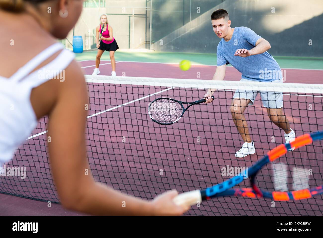 Young man playing tennis on court Stock Photo - Alamy