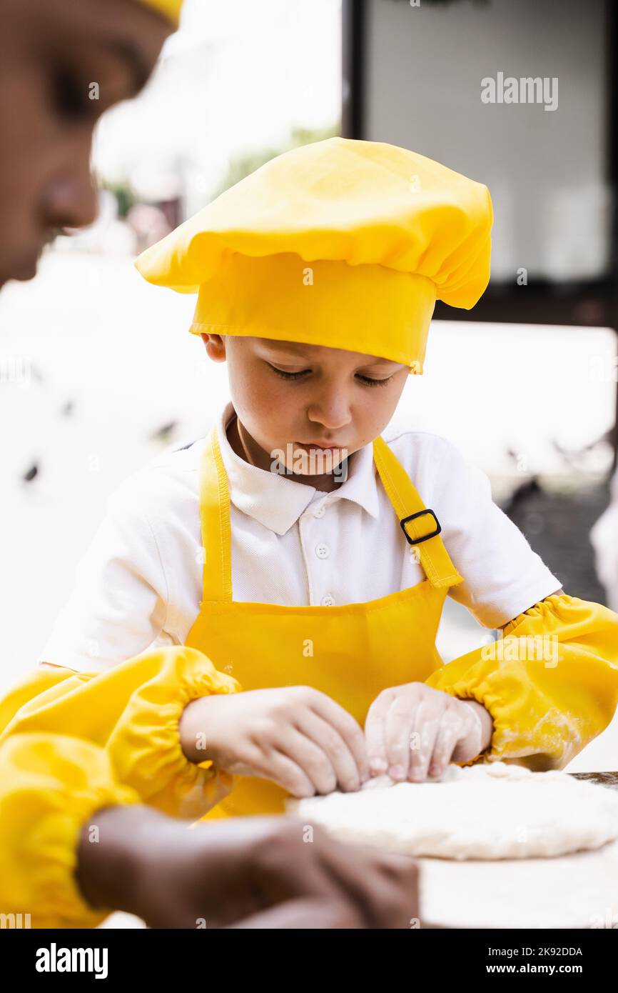 Handsome cook child in yellow chefs hat and apron yellow uniform ...