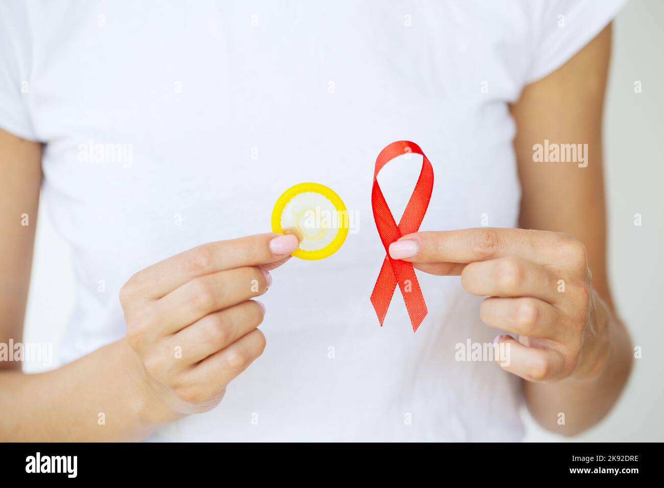 Woman hand holding red ribbon HIV world AIDS day awareness ribbon Stock ...