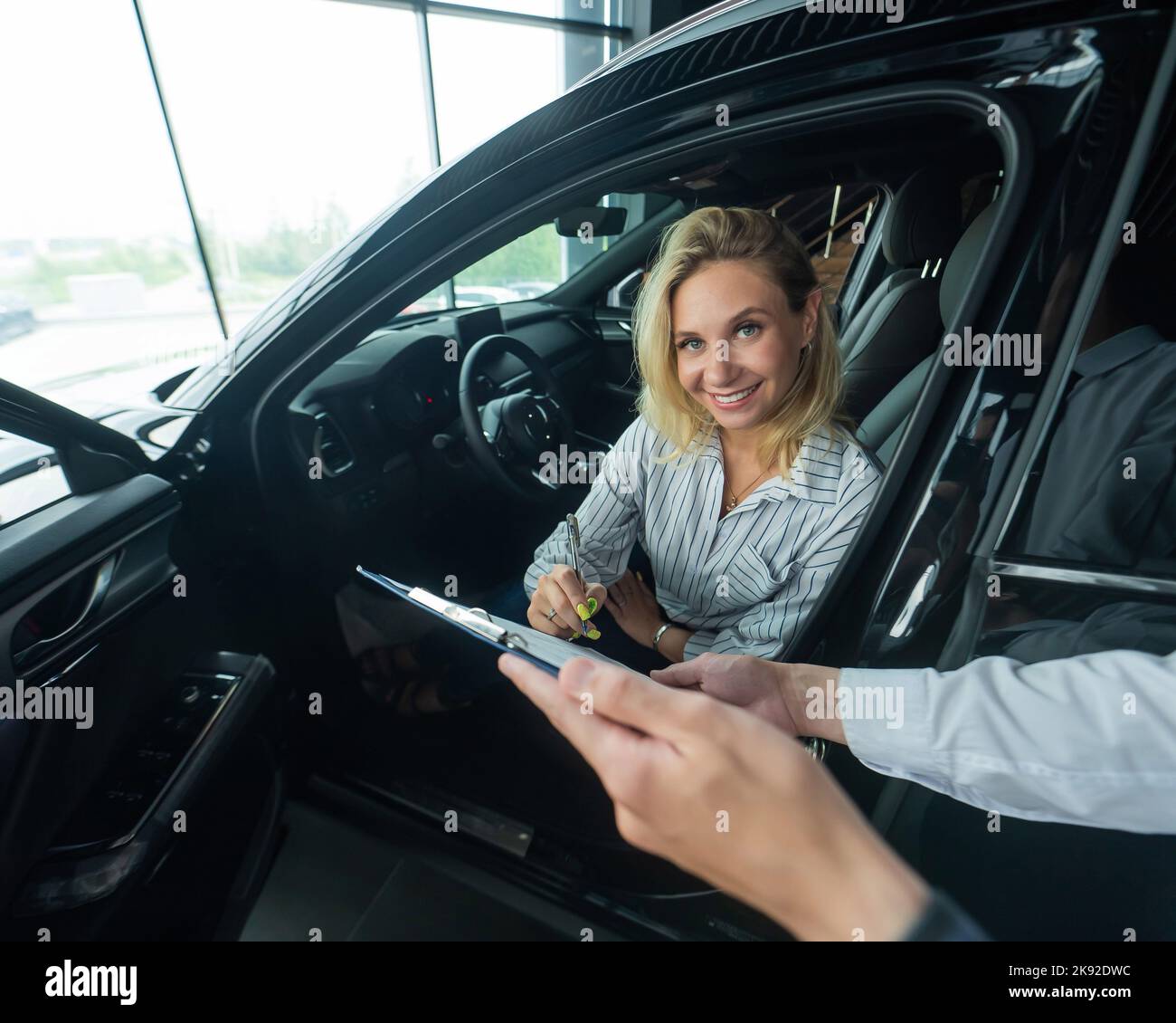 Girl signing document sitting hi-res stock photography and images - Alamy