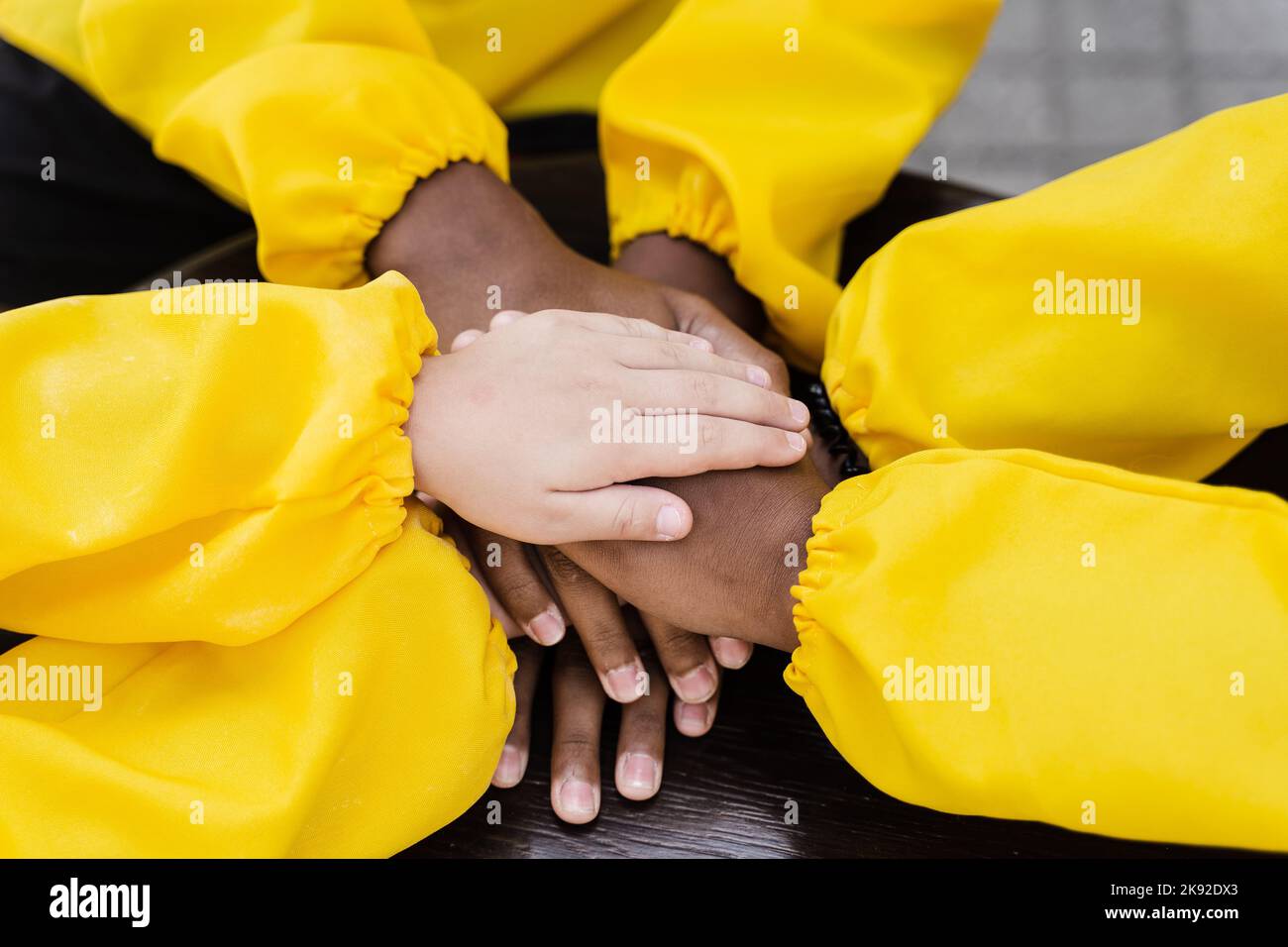 Multiracial children hands together forming pile close-up. Friendship ...