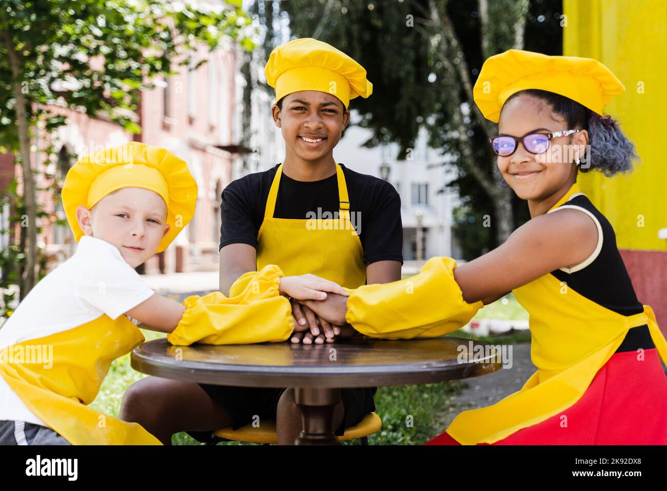 Multiracial children cook touching hands together forming pile ...
